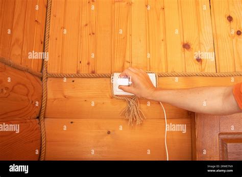 A Woman S Hand Inserts A Charger Into A Socket On The Wall Inserting A Plug Into A Socket On