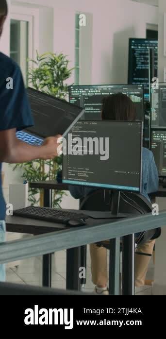 Vertical Video African American Developer Using Laptop To Write Code And Display System