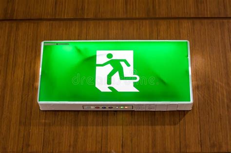 Illuminated Green Exit Sign Suspended From The Ceiling Stock Photo Image Of Green Person