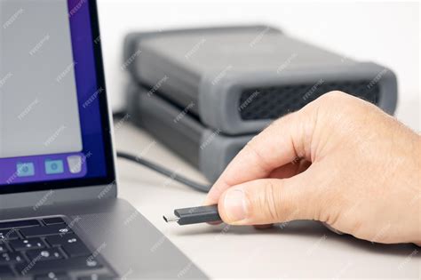 Premium Photo Male Hand Connecting A External Hard Drive Storage To A Modern Laptop Computer