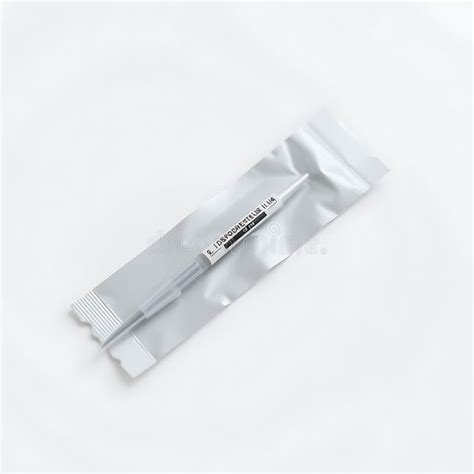 A Disposable Needle In Sterile Packaging Placed On A White Surface