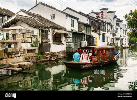 Women Dressed In Traditional Clothes On A Tourist Boat On Pingjiang River Alongside Pingjiang Lu
