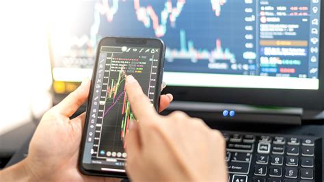 Female Trader Investor Broker Analyst Holding A Smartphone In Hand Analyzing Stock Market