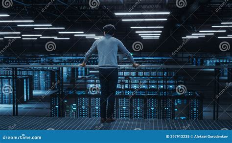Data Center Engineer Looking Down From A Balcony On Server Farm Cloud Computing Specialist