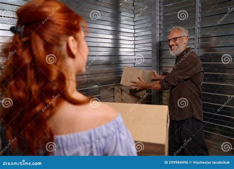 Female Helping Man Loading Boxes Into Storage Container Stock Photo Image Of Owner