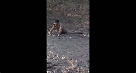 This Naked Man Failing To Conquer A Muddy Hill At A Festival Is A Modern Parable