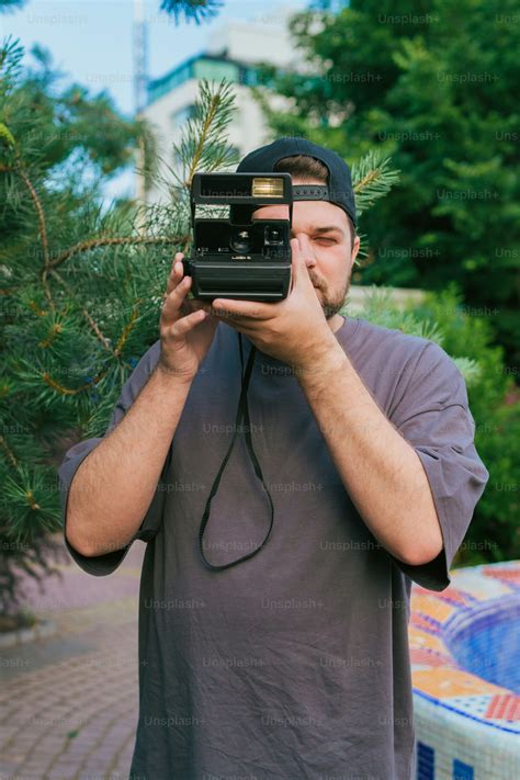 A Woman Holding A Polaroid Camera And A Polaroid Card Photo Polaroid Image On Unsplash