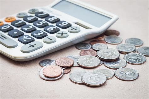Calculator With Coins Stock Photo At Vecteezy