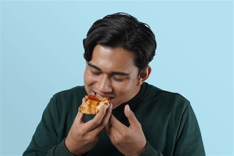 Premium Photo Happy Asian Man Guy Eating Tasty Italian Pizza Enjoying