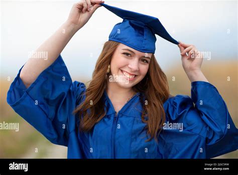 A Pretty High School Senior Girl Holding Her Cap With Her Graduation