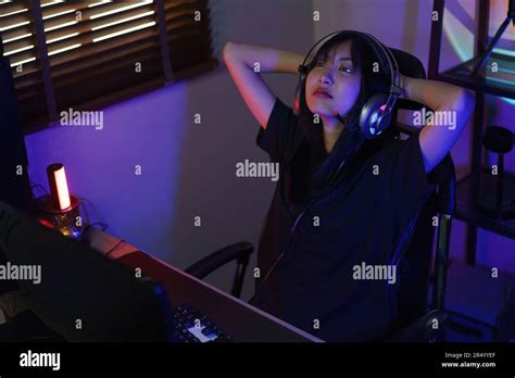 Female Cyber Hacker Gamer Holds Hands Behind Head To Resting After