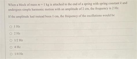 solved when a block of mass m 1 kg is attached to the end of