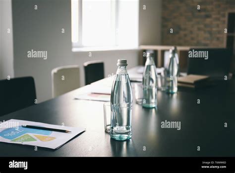 Table With Bottles Of Water Prepared For Business Meeting In Conference
