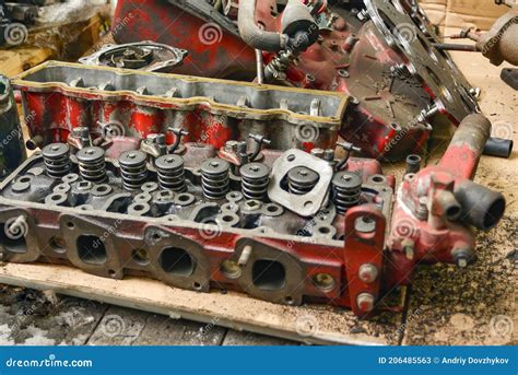 Exploded View Of The Cylinder Head Of A Four Cylinder Engine Being Repaired In A Car Workshop