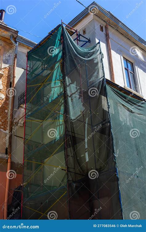 Building With Scaffolding Covered With White Scaffold Mesh Royalty Free Stock Image