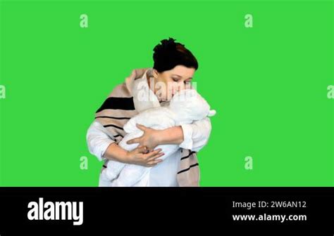 Happy Grandmother Cuddling Her Granddaughter Or Grandson On A Green