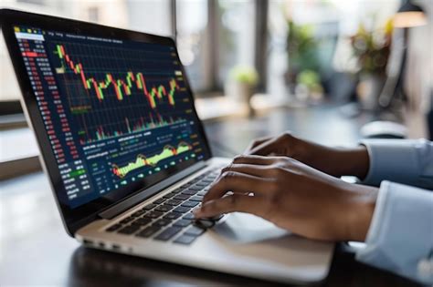 Trader Analyzing Stock Market Trends On Laptop At Workplace Premium