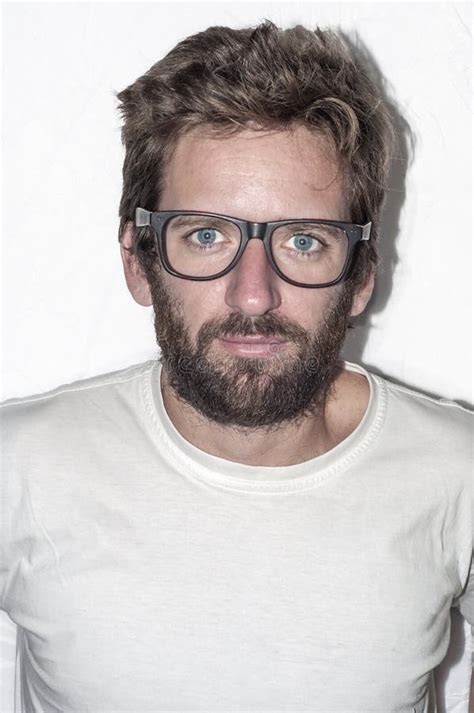 Caucasian Blond Haired Man With Glasses Wearing A White Shirt Looking