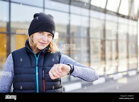 Fit Woman Looking At Smartwatch And Counting Calories Burned Woman Standing Relaxed After