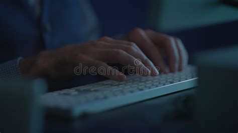 Focused Hands Skillfully Typing On A Keyboard While In A Dark And Immersive Environment Stock