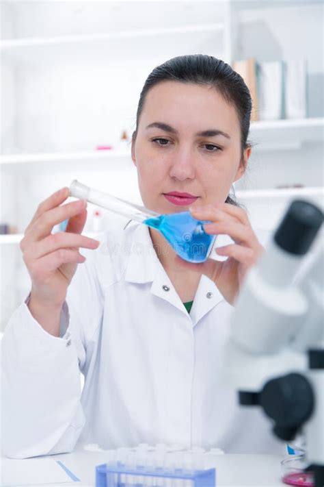 Young Female Scientist Analyzing Sample In Laboratory Laboratory Assistant Analyzing A Sample