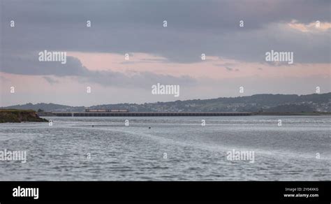 Northern Rail Class 156 Sprinter Train Crossing The Kent Viaduct At Arnside On The Scenic
