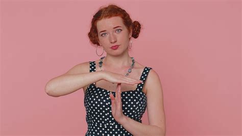 Tired Serious Upset Young Redhead Woman In Dress Showing Pause Gesture