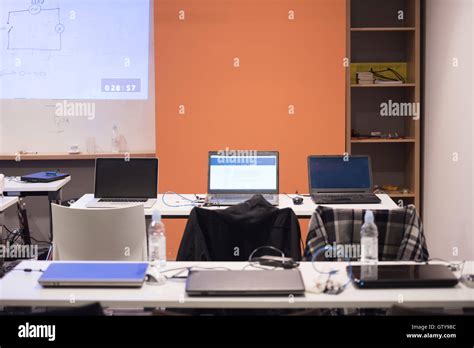 Empty It Classroom With Program Code On Projector Screen And Modern Laptop Computers On Table