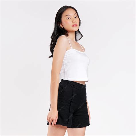 Premium Photo A Young Woman Wearing A White Top And Black Shorts