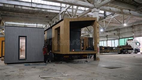 Prefabricated Tiny Houses Moving On A Trailer Inside A Large Warehouse