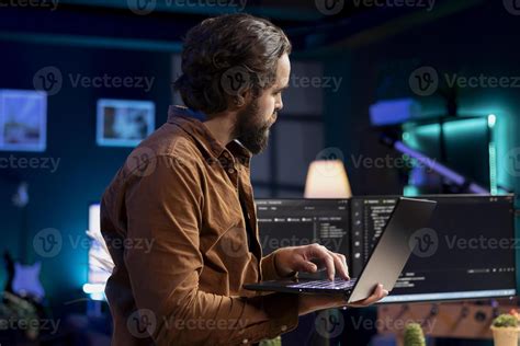 Man Doing Software Quality Assurance Reading Source Code On Laptop