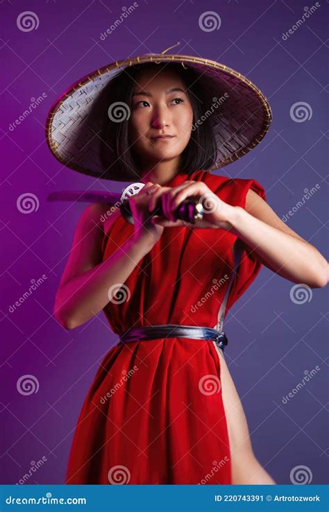 Portrait Of An Asian Woman In A Red Cape And An Asian Hat With A Katana In Her Hand Image Of A