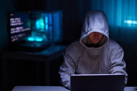 Premium Photo Hacker Using The Computer Man In A Hoodie Breaks The
