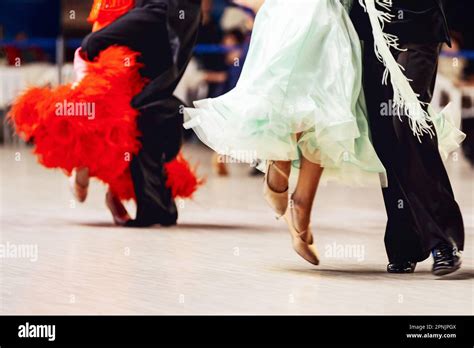 Couples Dancing Viennese Waltz In Competitive Ballroom Dancesport