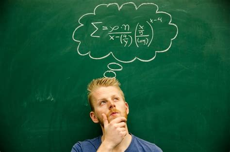 Premium Photo Man With Mathematical Formula On Blackboard