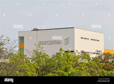 The Ericsson Logo Is Prominently Displayed On A Building Blending