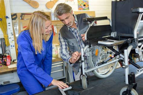 Man And Woman Assembling Wheelchair Colourbox
