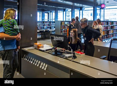 Two Female Librarians At Work Behind Computer Screen In Public Library Stock Photo Alamy