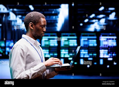 African American System Administrator Typing Supercomputer Hub