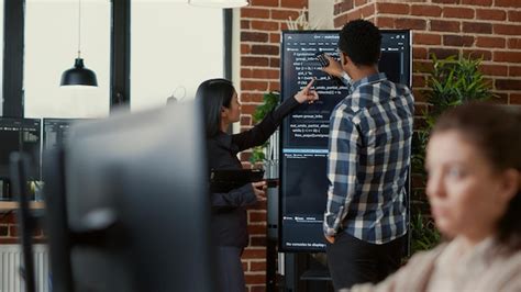 premium photo system developers analyzing code on wall screen tv