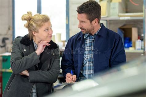 Male Mechanic With Female Customer In Garage Stock Photo Image Of