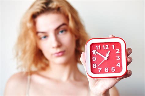 Premium Photo Woman Holds Red Alarm Clock In Her Hand Male Sex