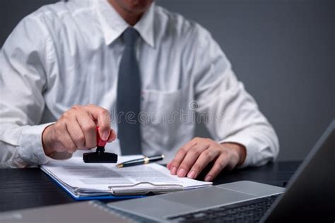 Business Professional Stamping A Document For Approval Perfect For Legal Contract Or Official