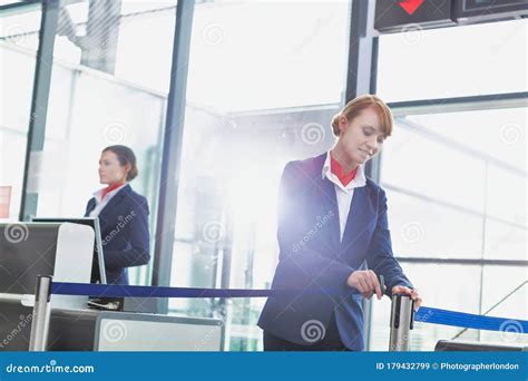 Portrait Of Young Attractive Passenger Service Agent Opening The Gate