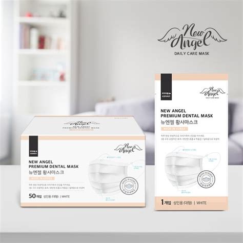 Two Boxes Of New Angel Premium Dental Masks Sitting On A Table In Front Of A Couch