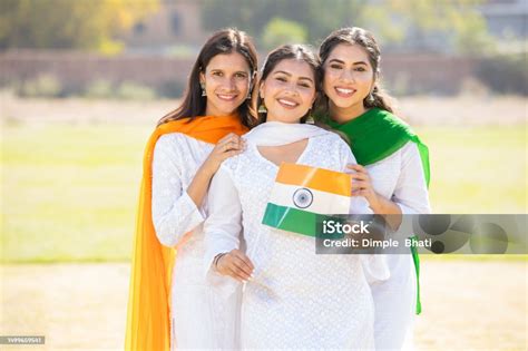 Three Young Beautiful Women Wearing Traditional White Dress Holding