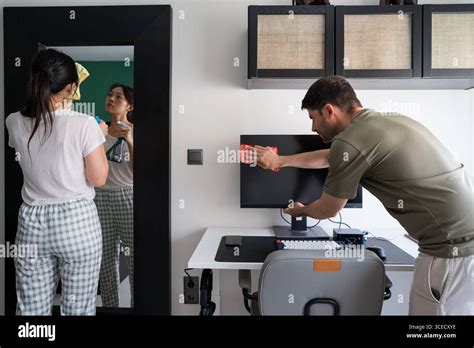 A Contemporary Couple Engaged In Household Chores Exemplifying Shared
