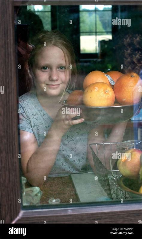 Young Preteen Girl Holding A Bowl Of Fruit Looking Through The Window Zawady Gmina Rzeczyca