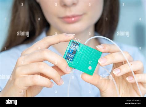 Young Scientist Woman In Microbiological Lab With Lab On Chip Loc Microfluidic Device Stock