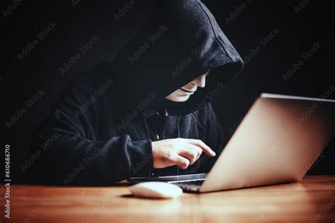 Black Hood Hacker In Hood Using Tablet On Desk To Hacking Privacy Sensitive Data Cyber Crime